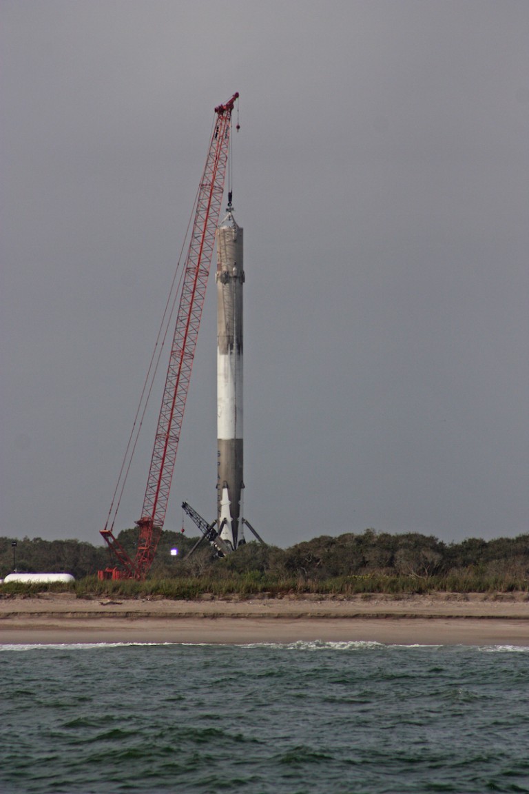 Photos: Falcon 9 booster stands upright after landing – Spaceflight Now