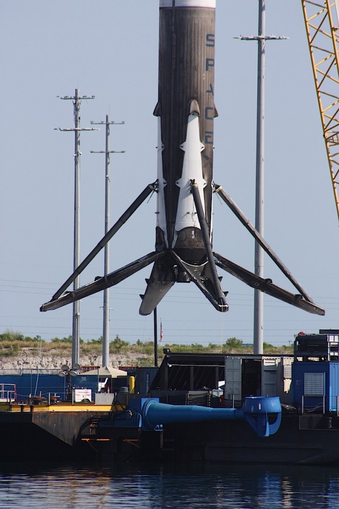 Flown Falcon 9 booster hoisted off landing platform – Spaceflight Now