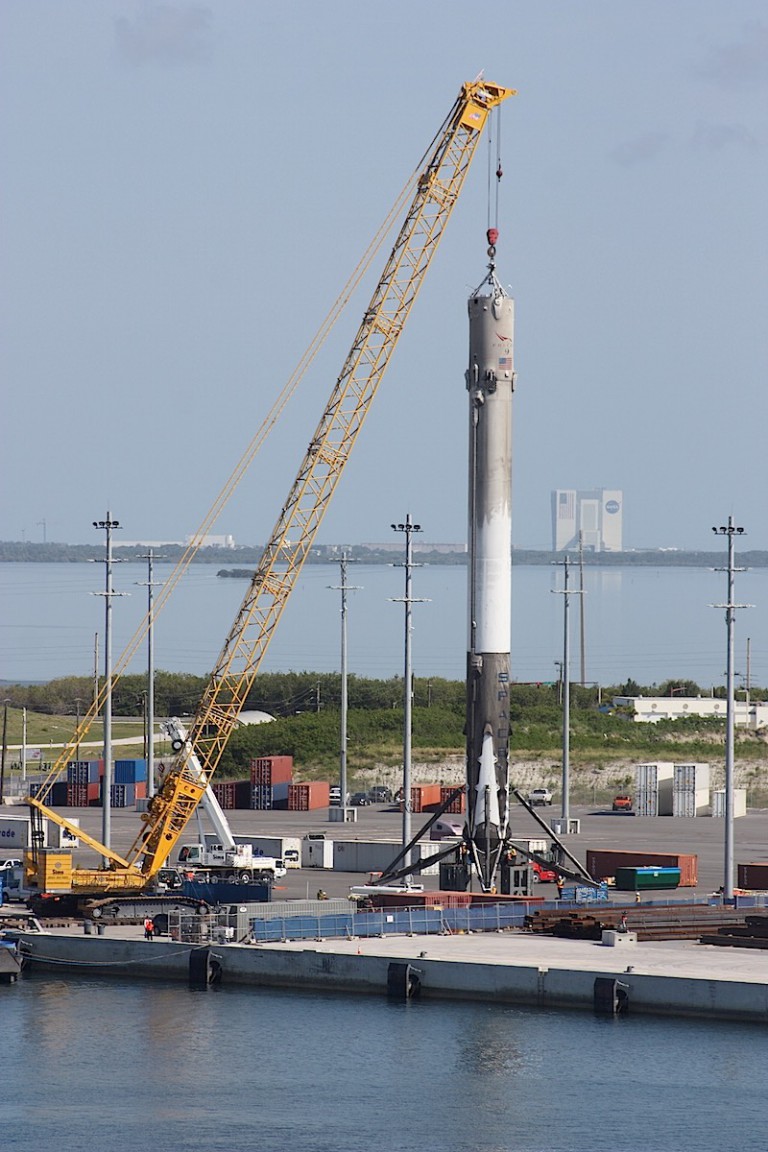 Flown Falcon 9 booster hoisted off landing platform – Spaceflight Now