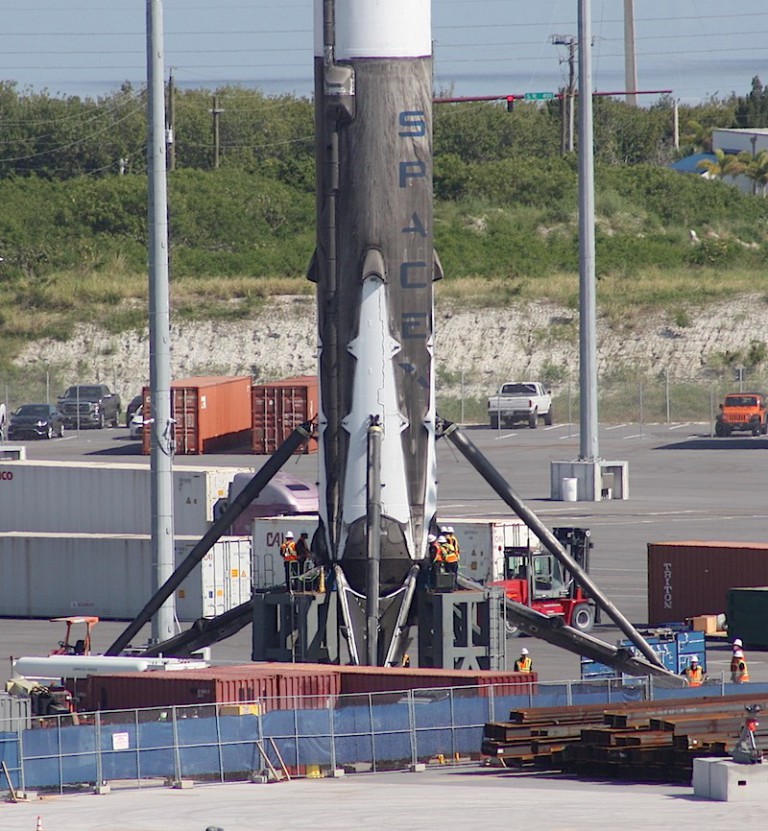 Flown Falcon 9 booster hoisted off landing platform – Spaceflight Now