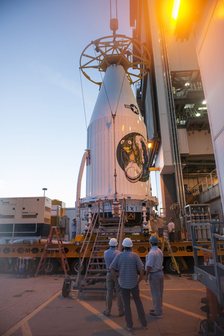 Photos: Payload with whimsical logo painted on nose cone lifted atop ...