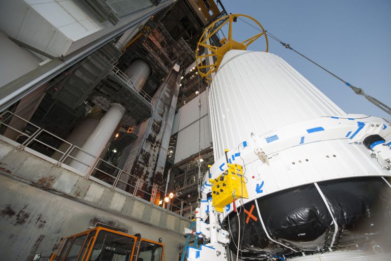 Photos: Payload with whimsical logo painted on nose cone lifted atop ...