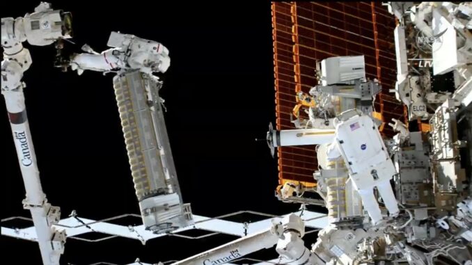 Astronauts install new solar array outside International Space Station ...