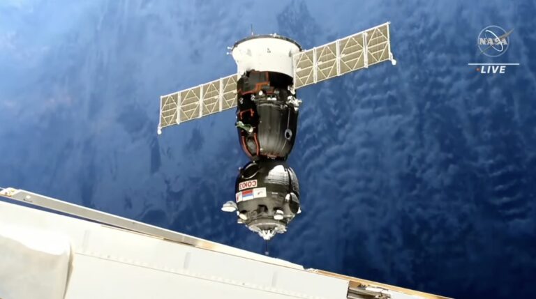 Unpiloted Soyuz spacecraft docks at space station to replace damaged ...